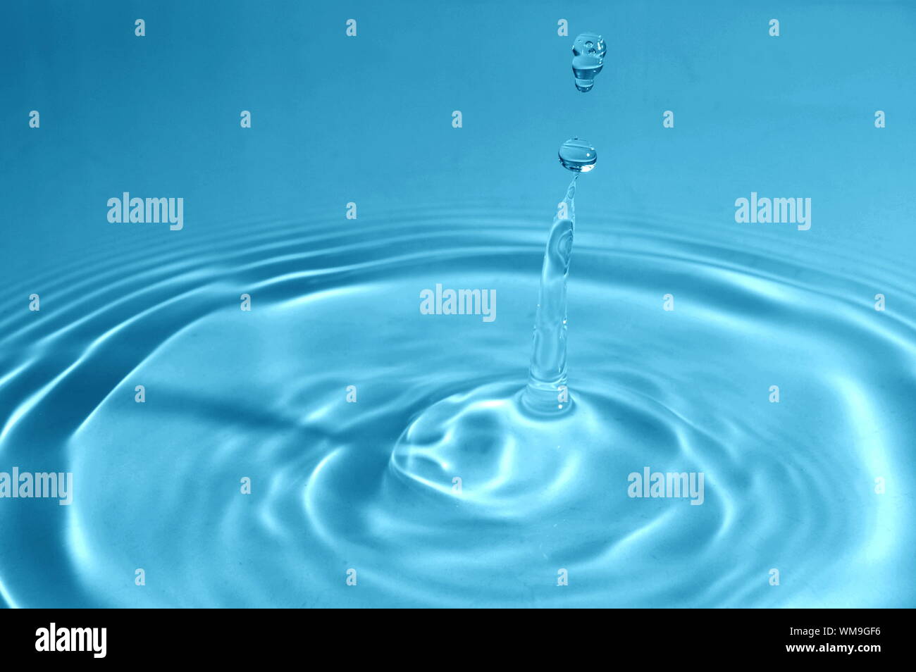 fresh water drop splashing in blue cool water Stock Photo - Alamy