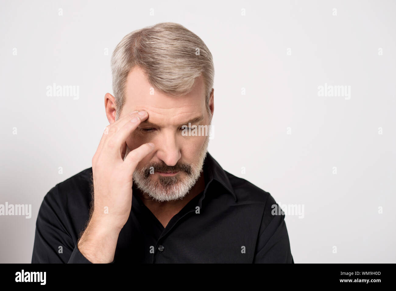 Senior man holding forehead hi-res stock photography and images - Alamy