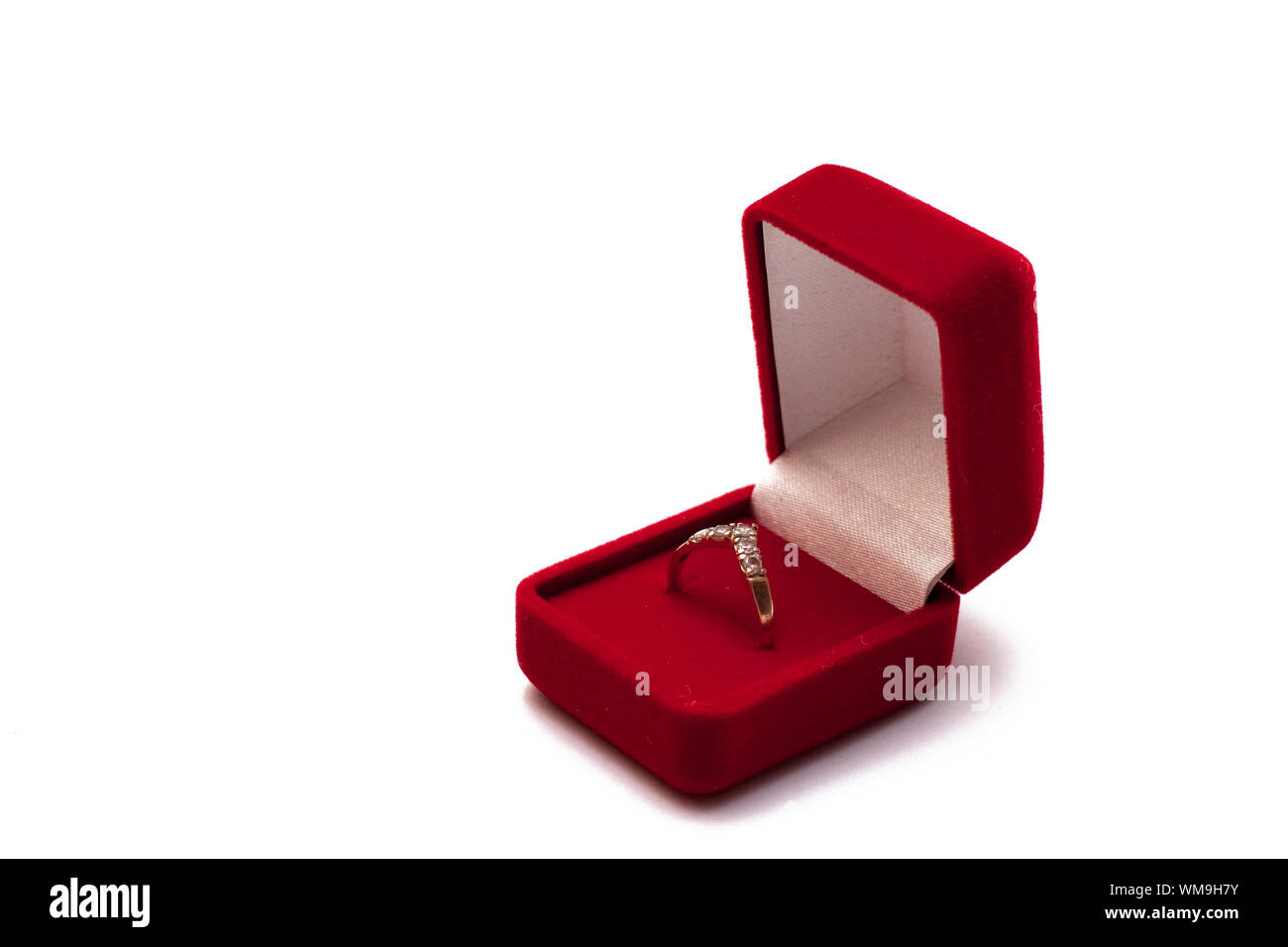 Engagement ring in an open red box isolated on white Stock Photo - Alamy