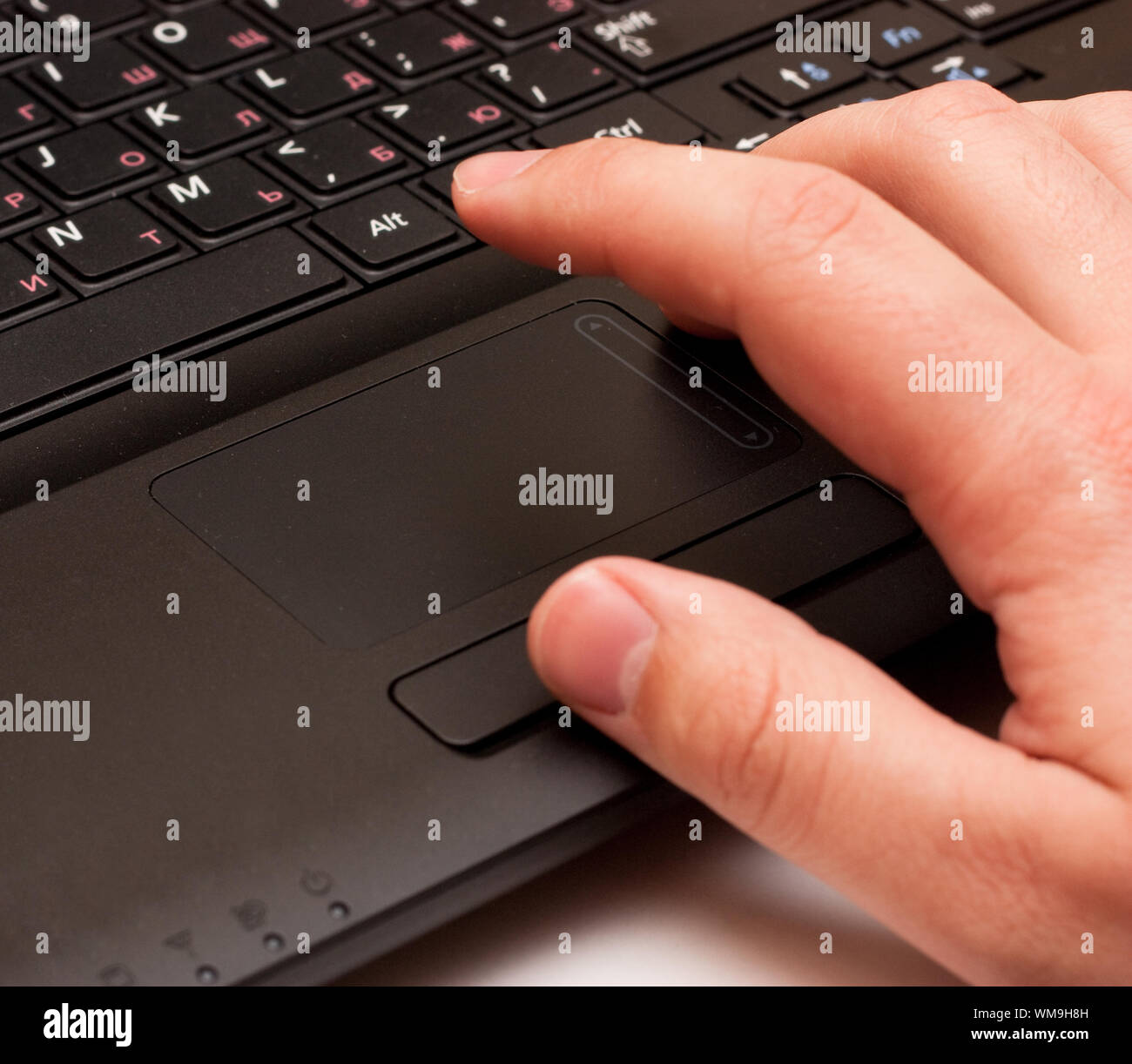 Using a laptop, finger on touchpad Stock Photo - Alamy
