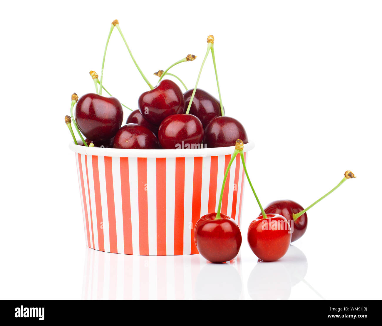 fresh cherry berries in striped bucket on white background Stock Photo ...