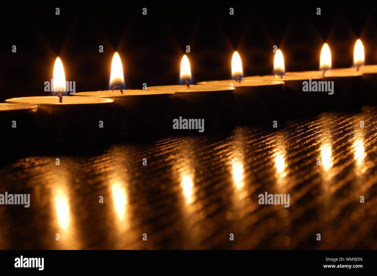 romantic hot candle light on black background Stock Photo - Alamy