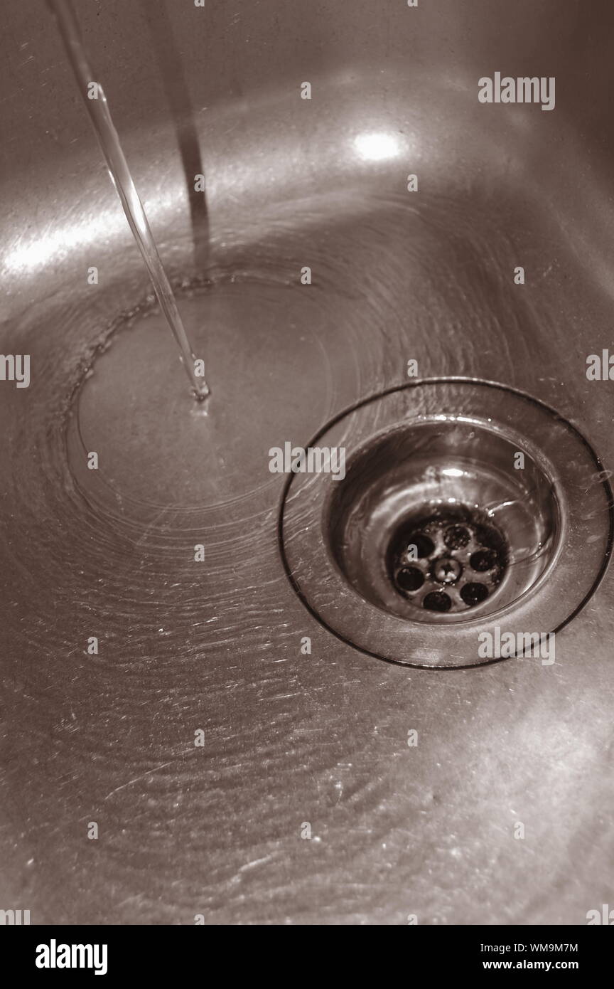 water flow into the drain in the kitchen Stock Photo - Alamy