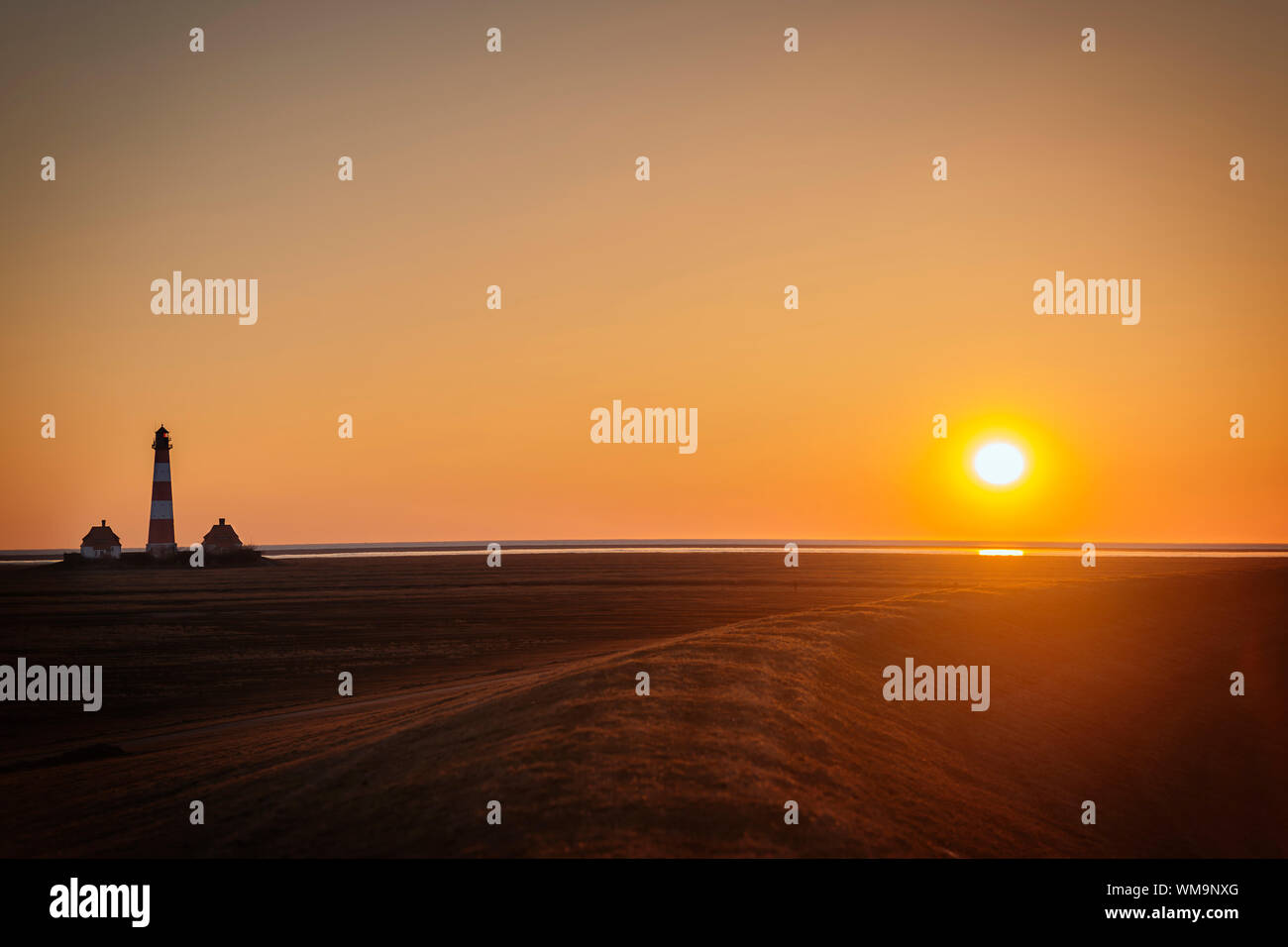 Image of a sunset on the dike of Westerhever in Northern Germany with ...