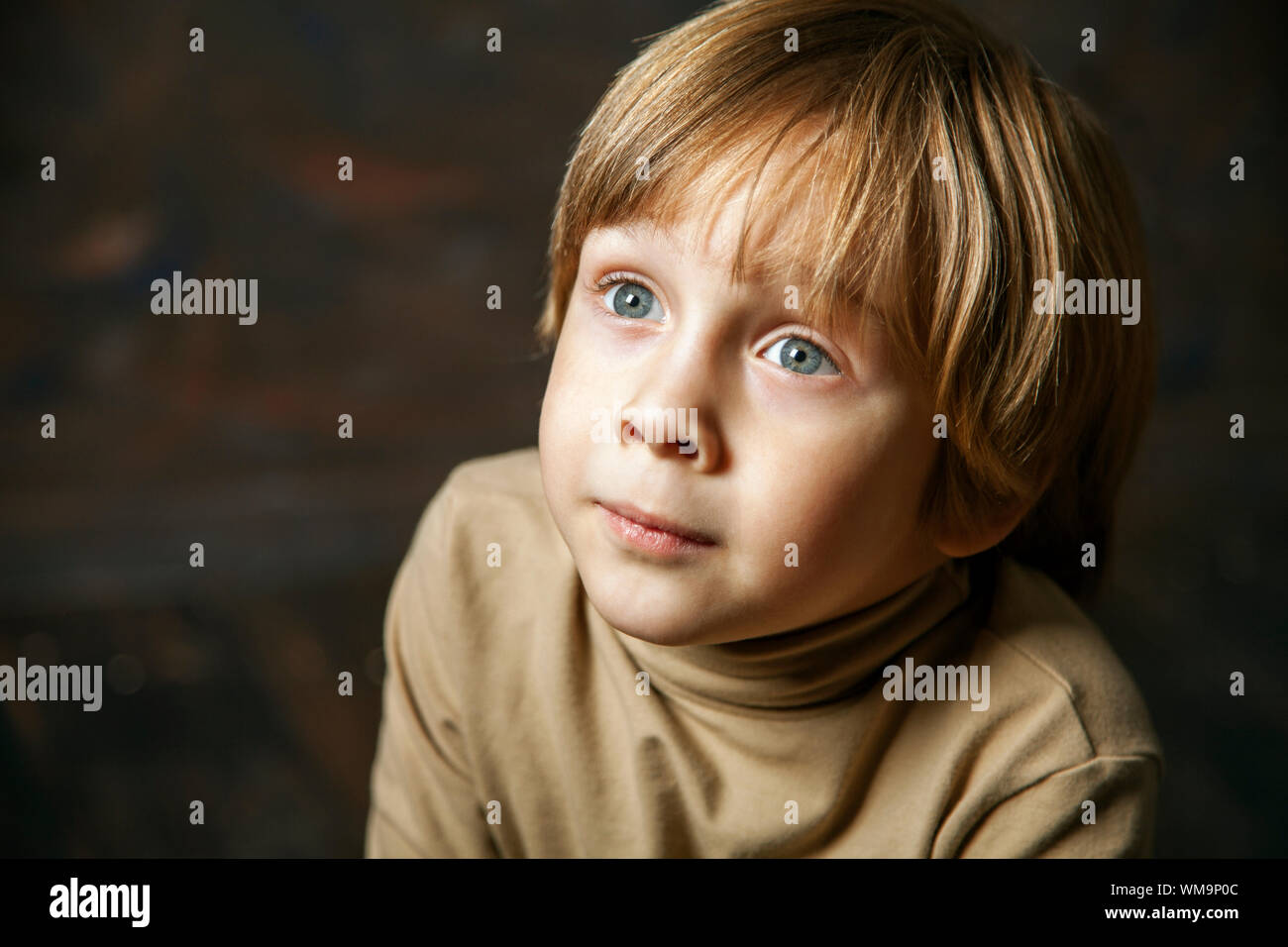 Little young beautiful boy spiritual peaceful praying and wishing ...