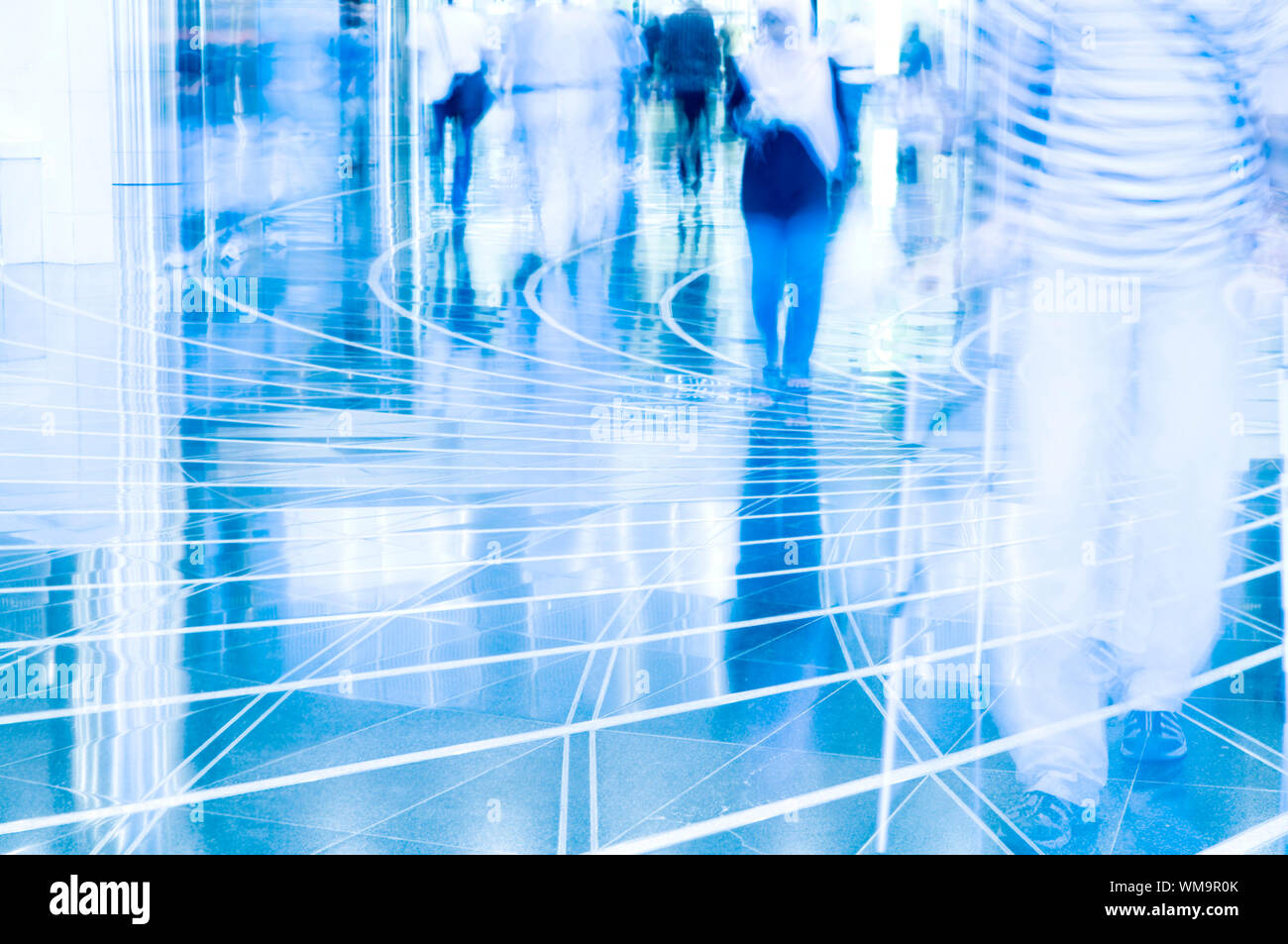 A shopping mall. Long exposure for intentional motion blur of people ...