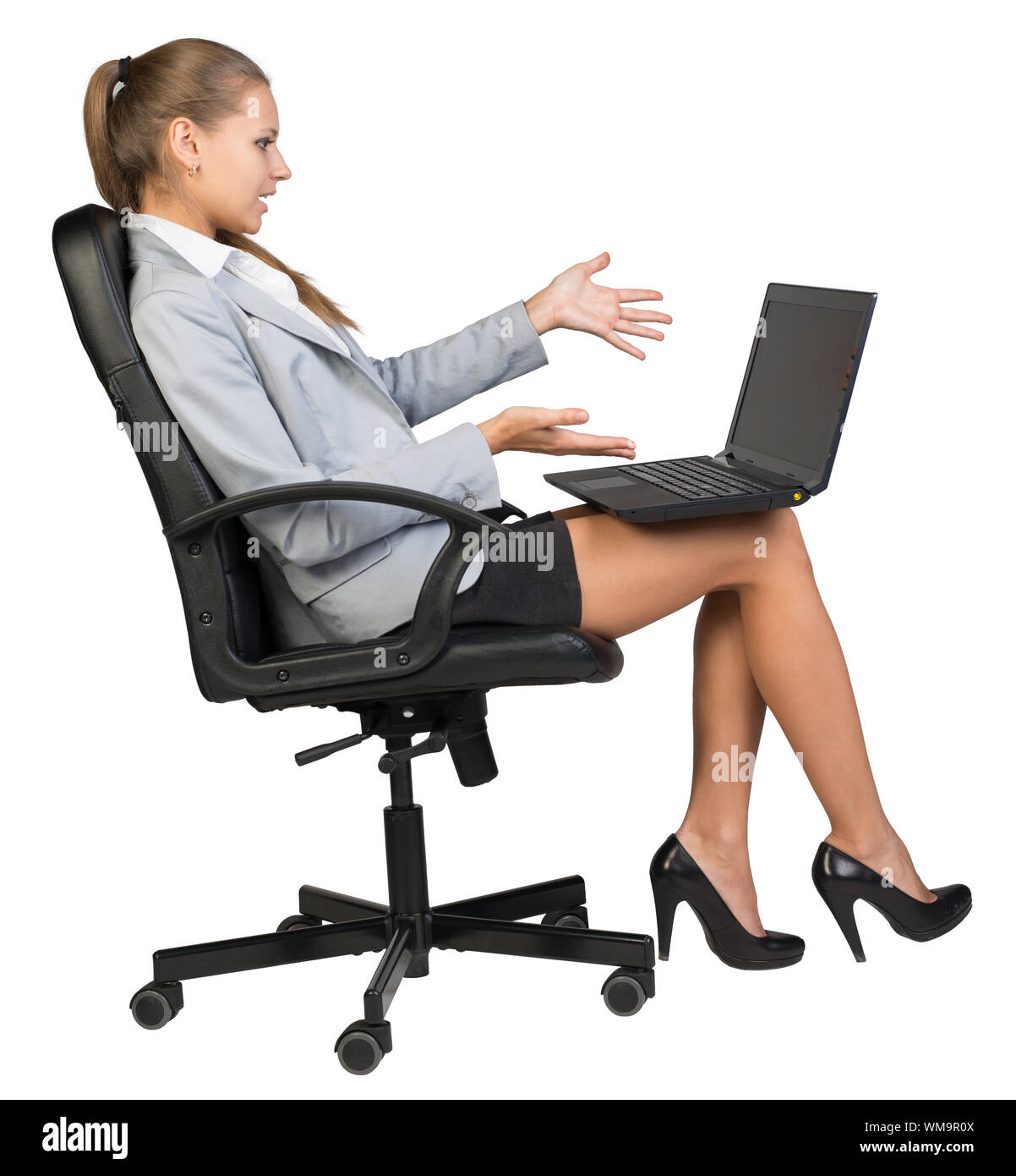 Businesswoman On Office Chair With Laptop On Her Knees Looking And businesswoman-on-office-chair-with-laptop-on-her-knees-looking-and