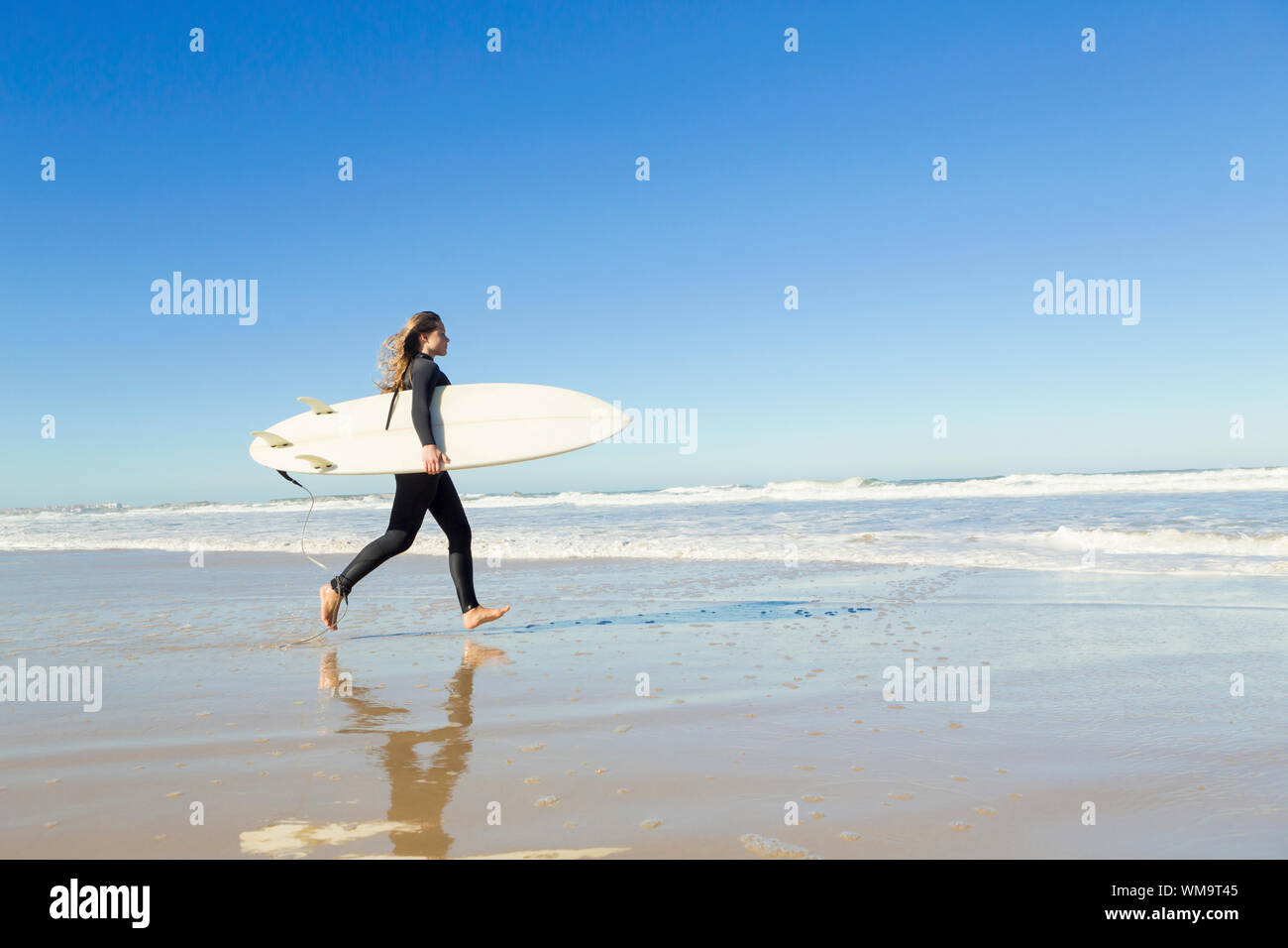 Run into ocean beach wetsuit hi-res stock photography and images - Alamy