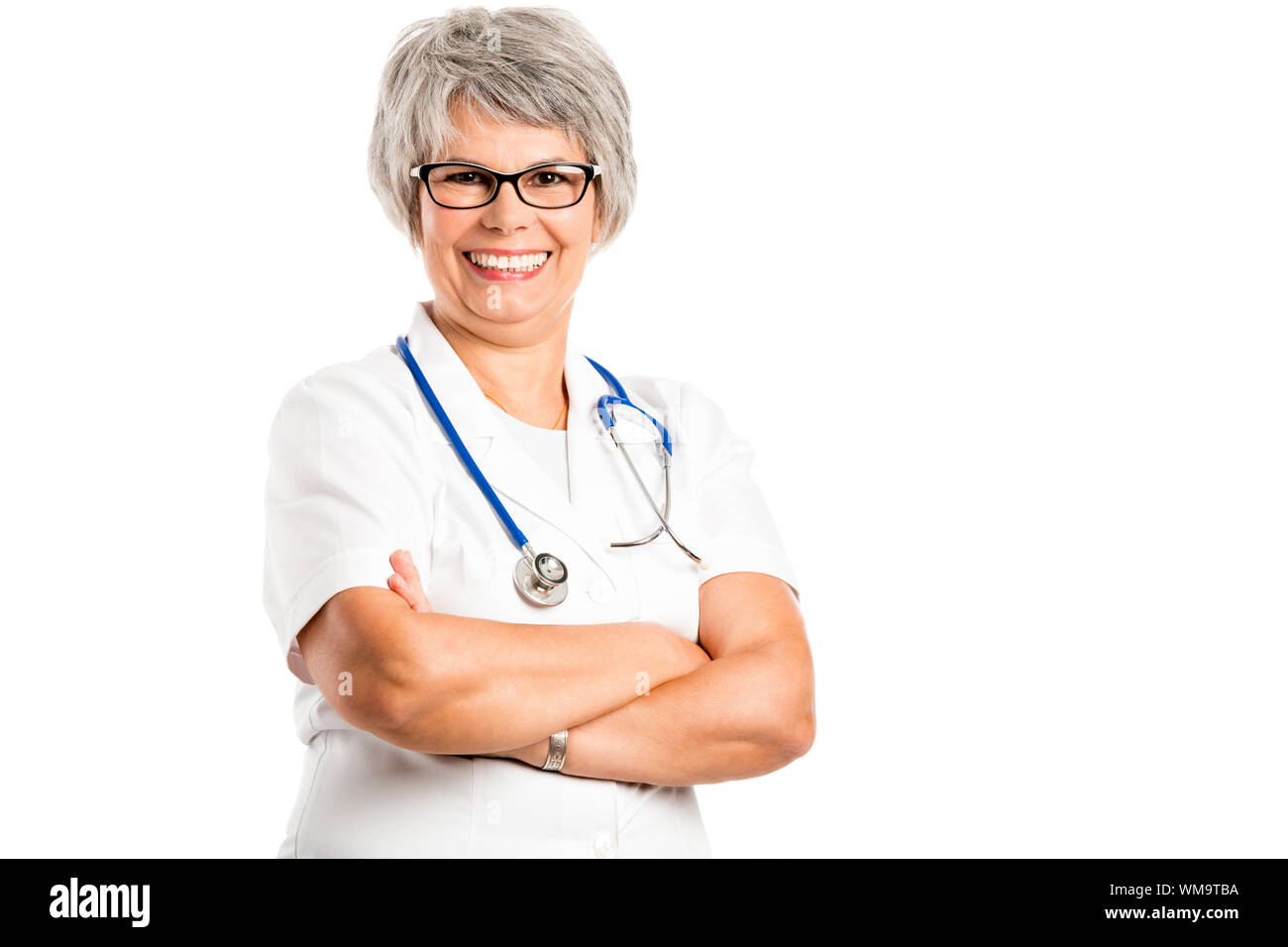 Happy old female doctor with hands folded, isolated on white Stock ...
