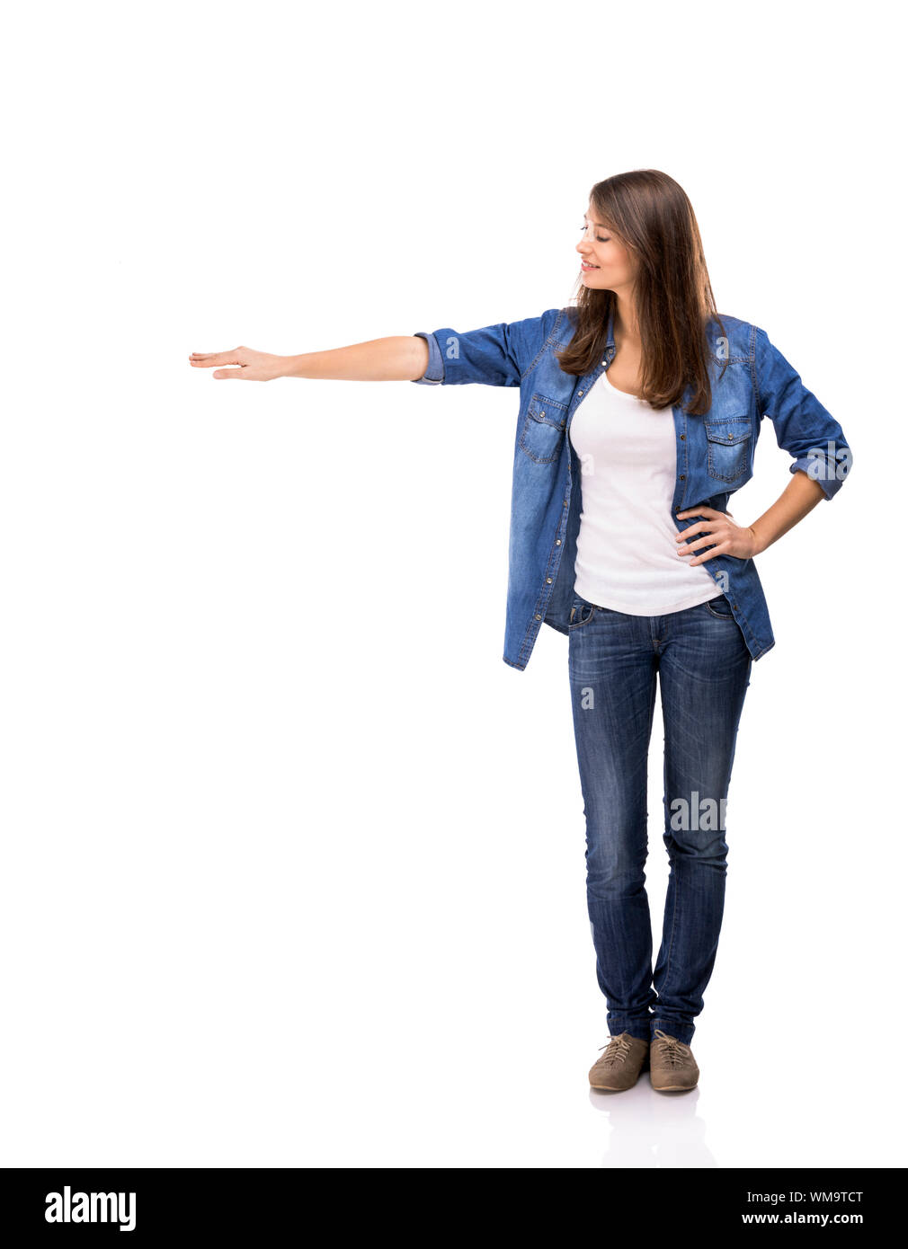 Beautiful woman standing over a white background with copyspace for the ...