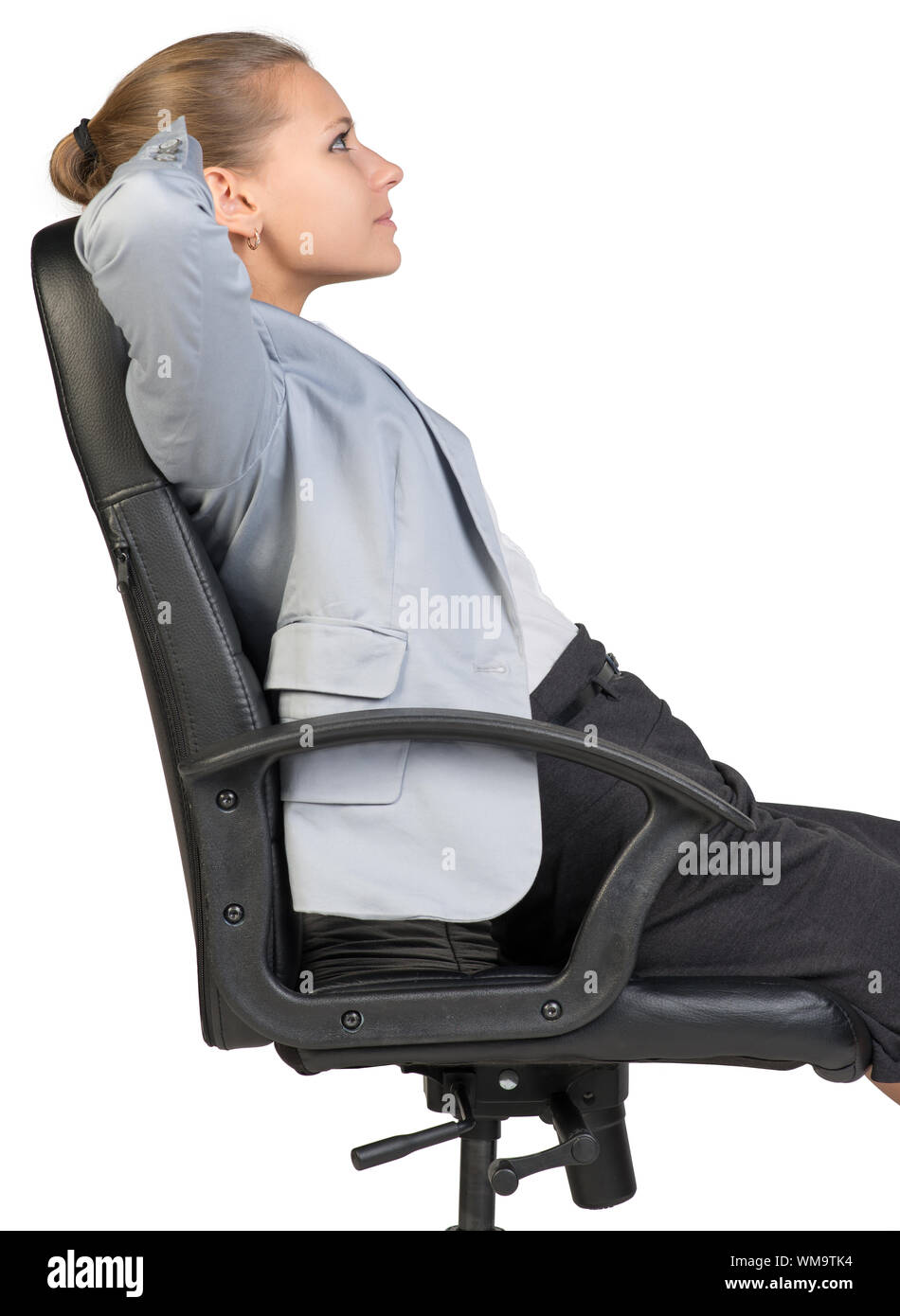 Businesswoman back in office chair with her hands clasped behind her ...
