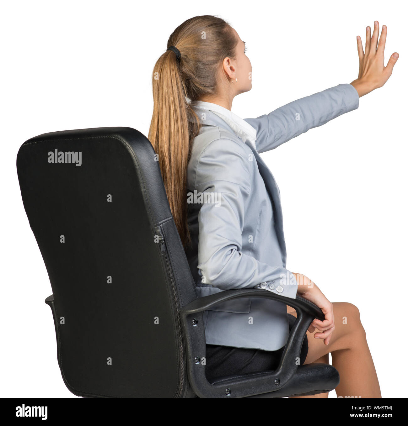 Businesswoman on office chair, with her hand reached upwards and ahead ...