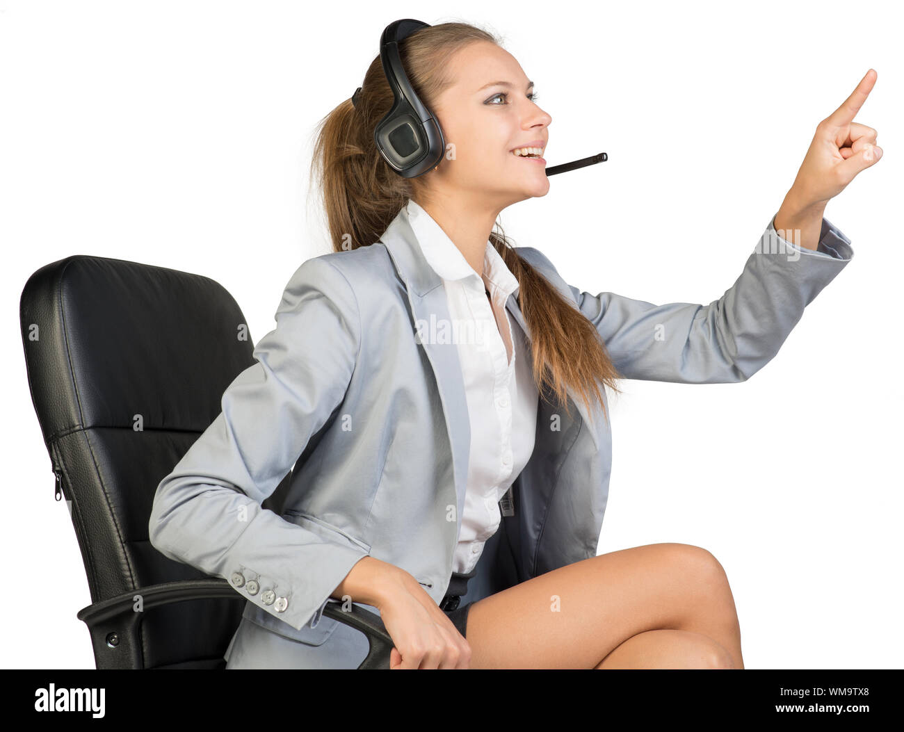 Businesswoman in headset sitting on office chair, touching or pressing ...