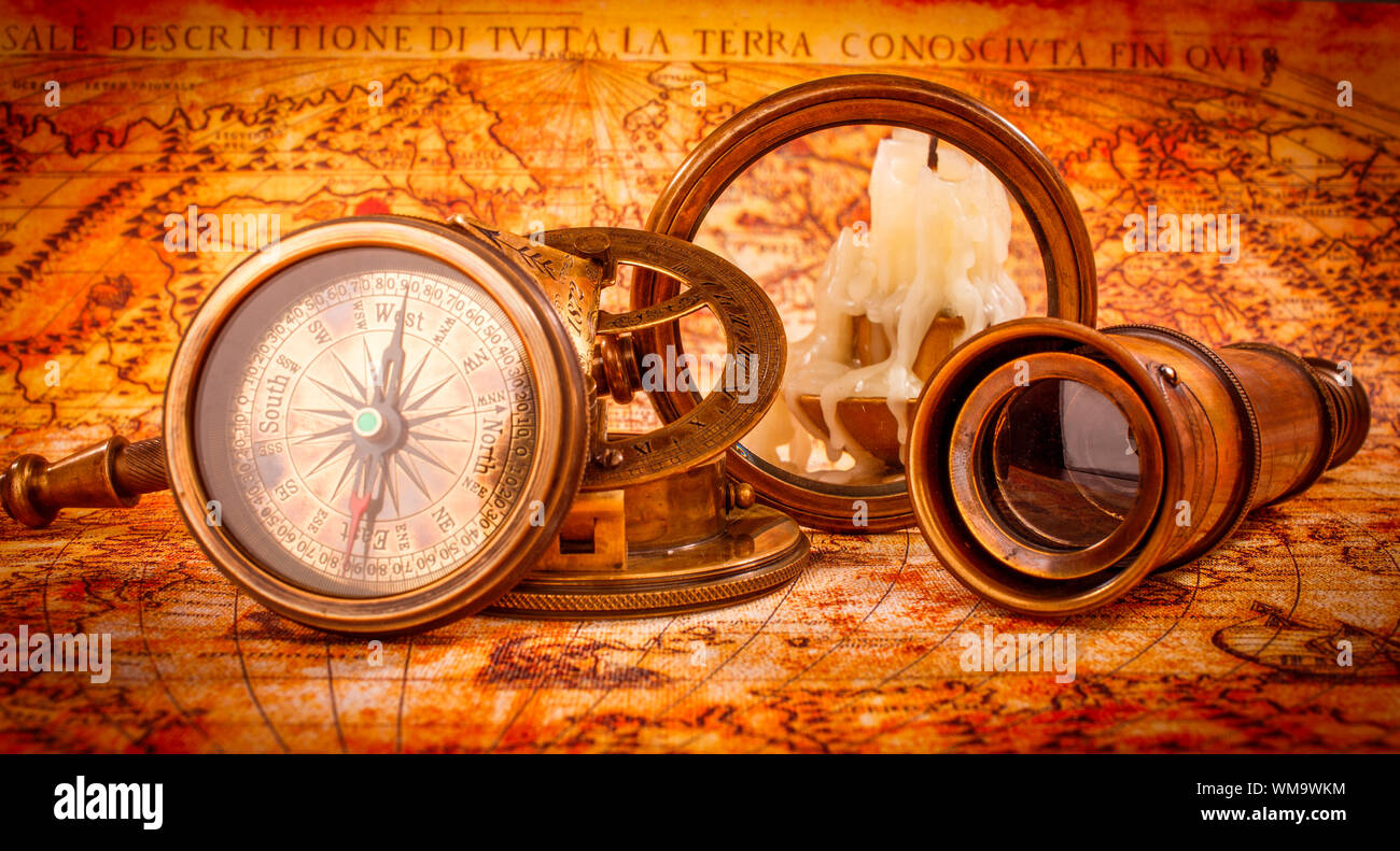 Vintage still life. Vintage magnifying glass lies on an ancient world ...