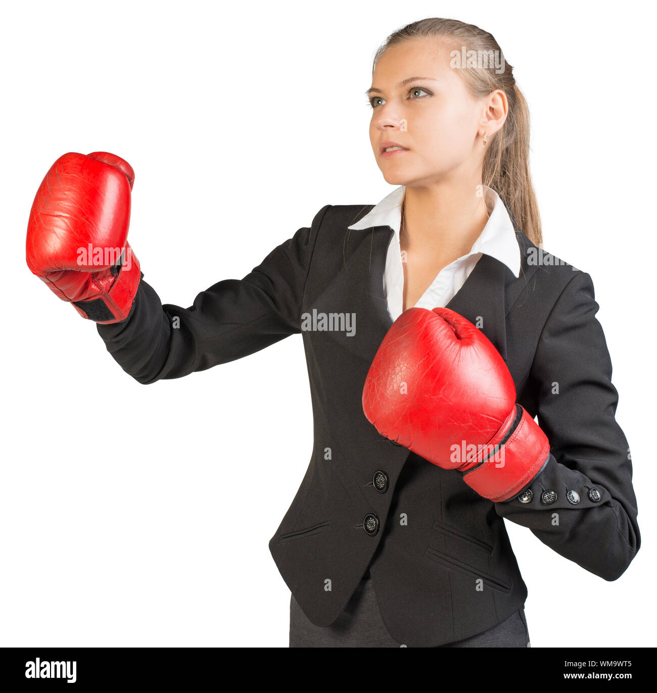 Businesswoman wearing boxing gloves standing in boxing stance, her lips ...