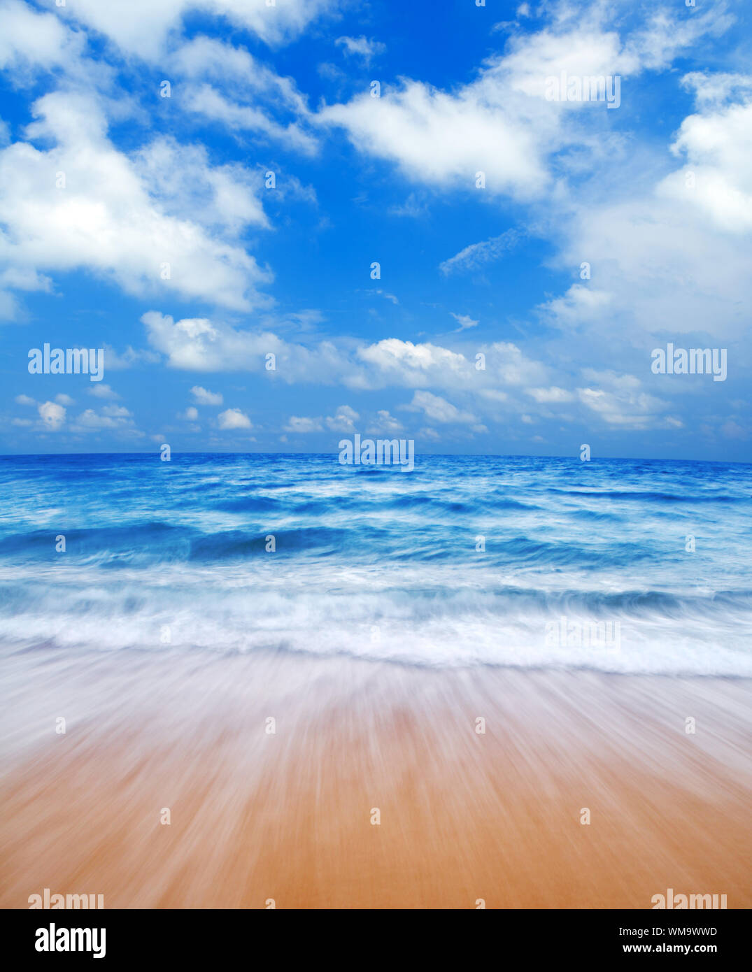 Summertime at beautiful blue beach with waves Stock Photo - Alamy