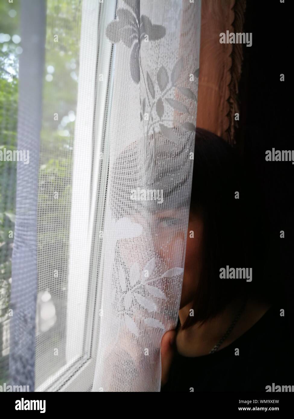 Hiding behind hair hi-res stock photography and images - Alamy