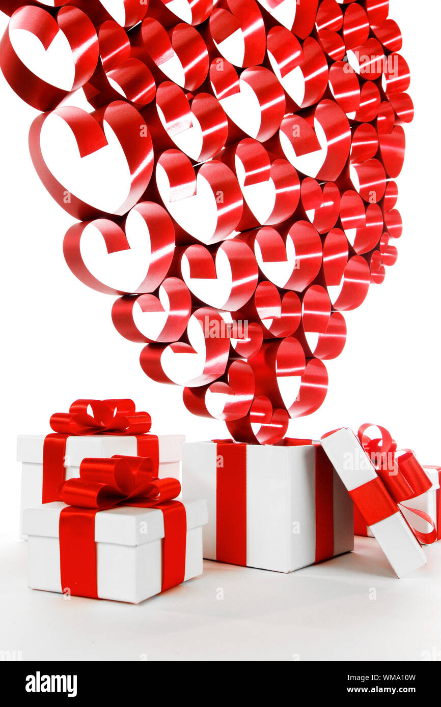 White boxes with red ribbons and decorative hearts isolated on white ...