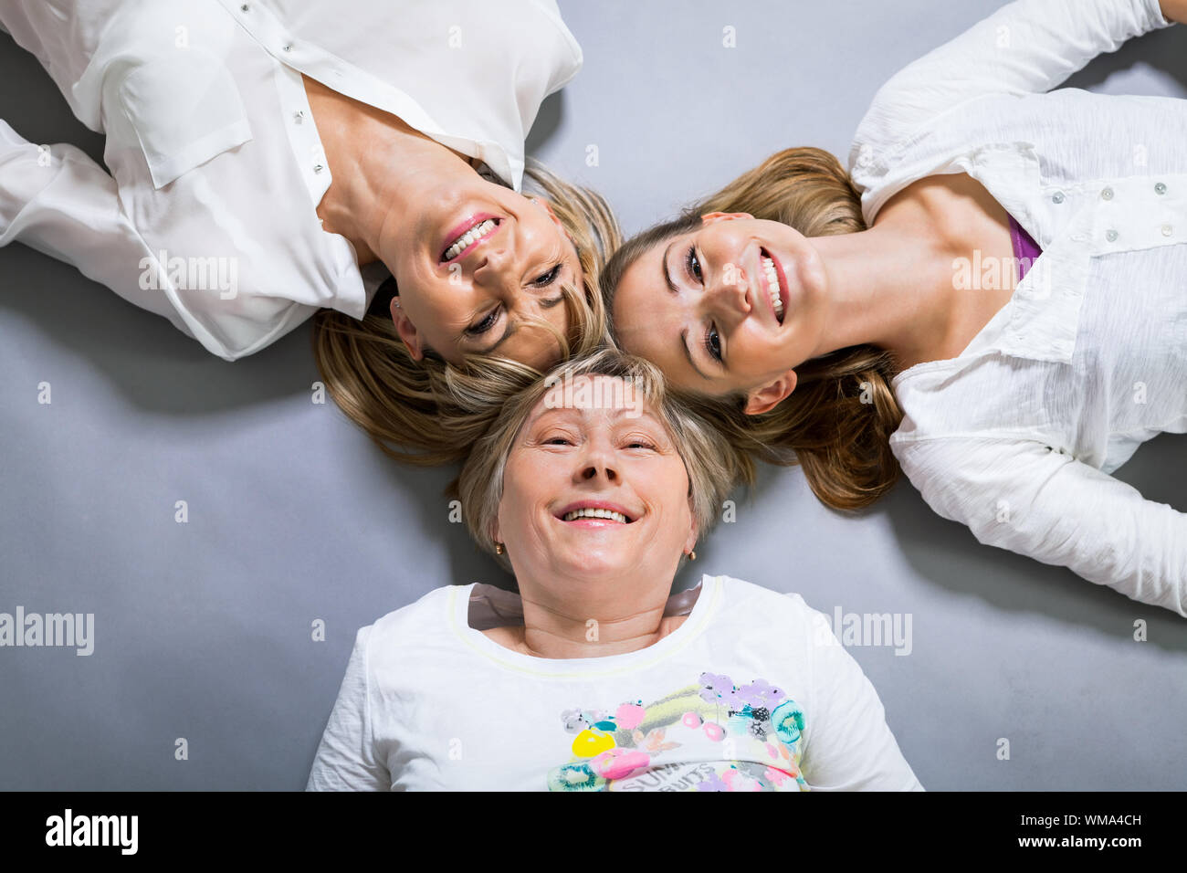 Three generations of attractive women with blond hair and a striking ...