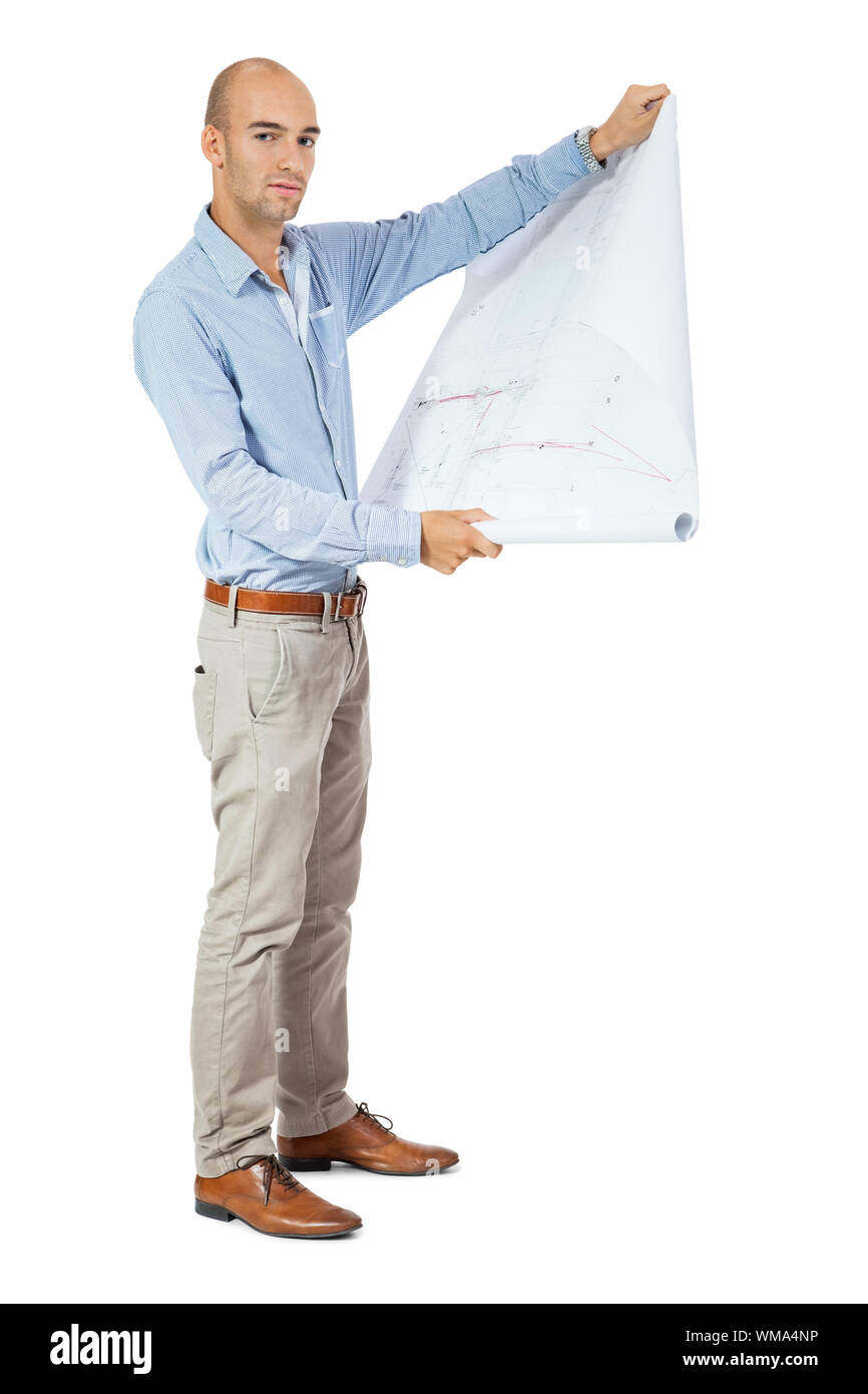 Architect or structural engineer standing reading an unrolled blueprint ...