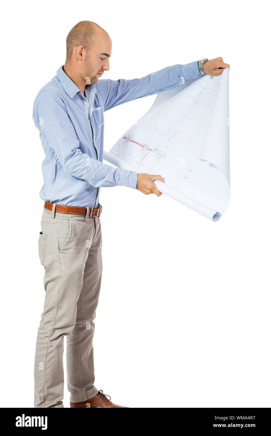 Architect or structural engineer standing reading an unrolled blueprint ...