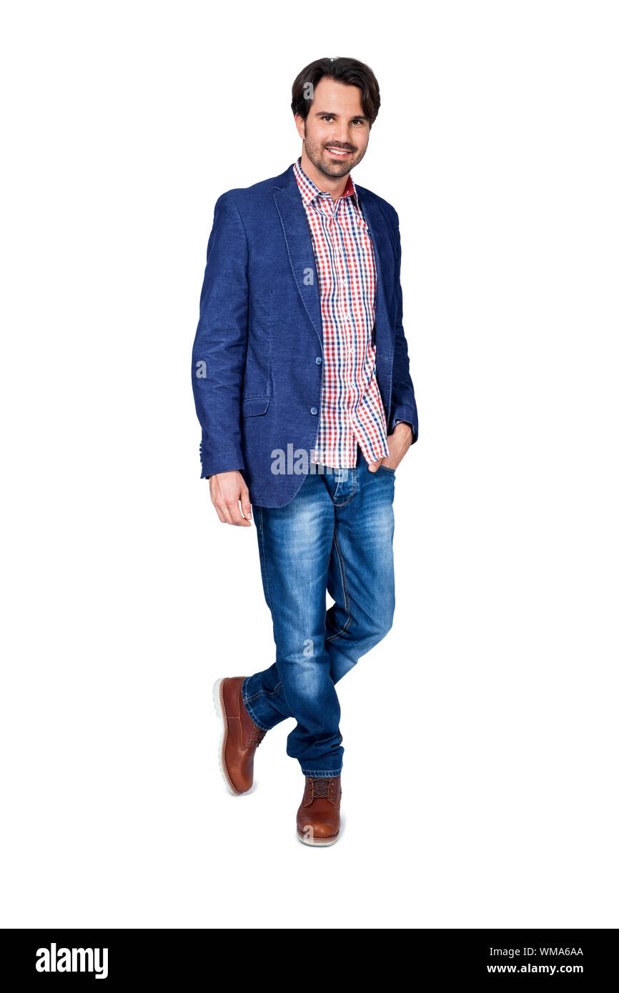 Handsome smiling man in stylish leisurewear approaching the camera in a ...