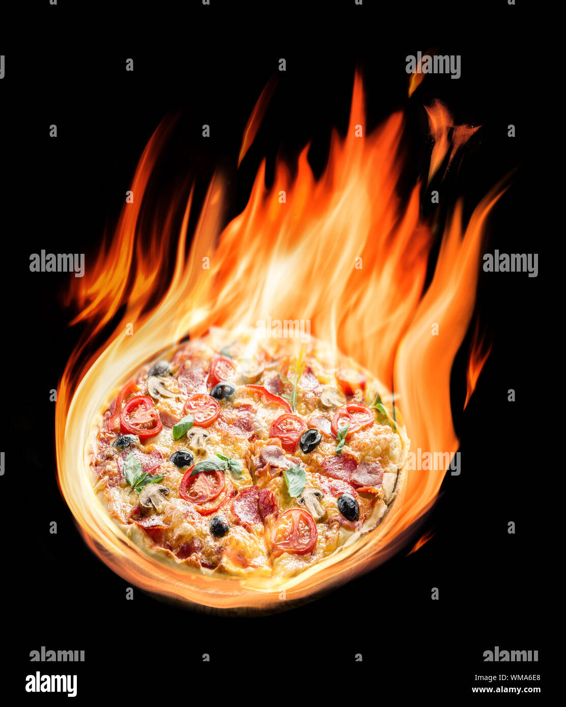 Burning pizza ingredients in flames on the black background Stock Photo ...