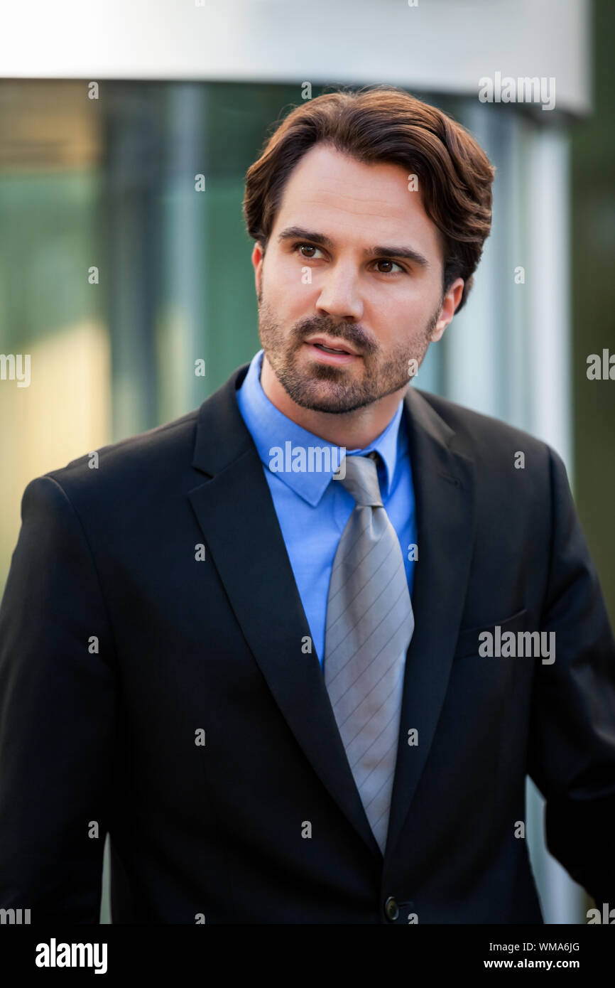 Businessman standing waiting for someone Stock Photo - Alamy