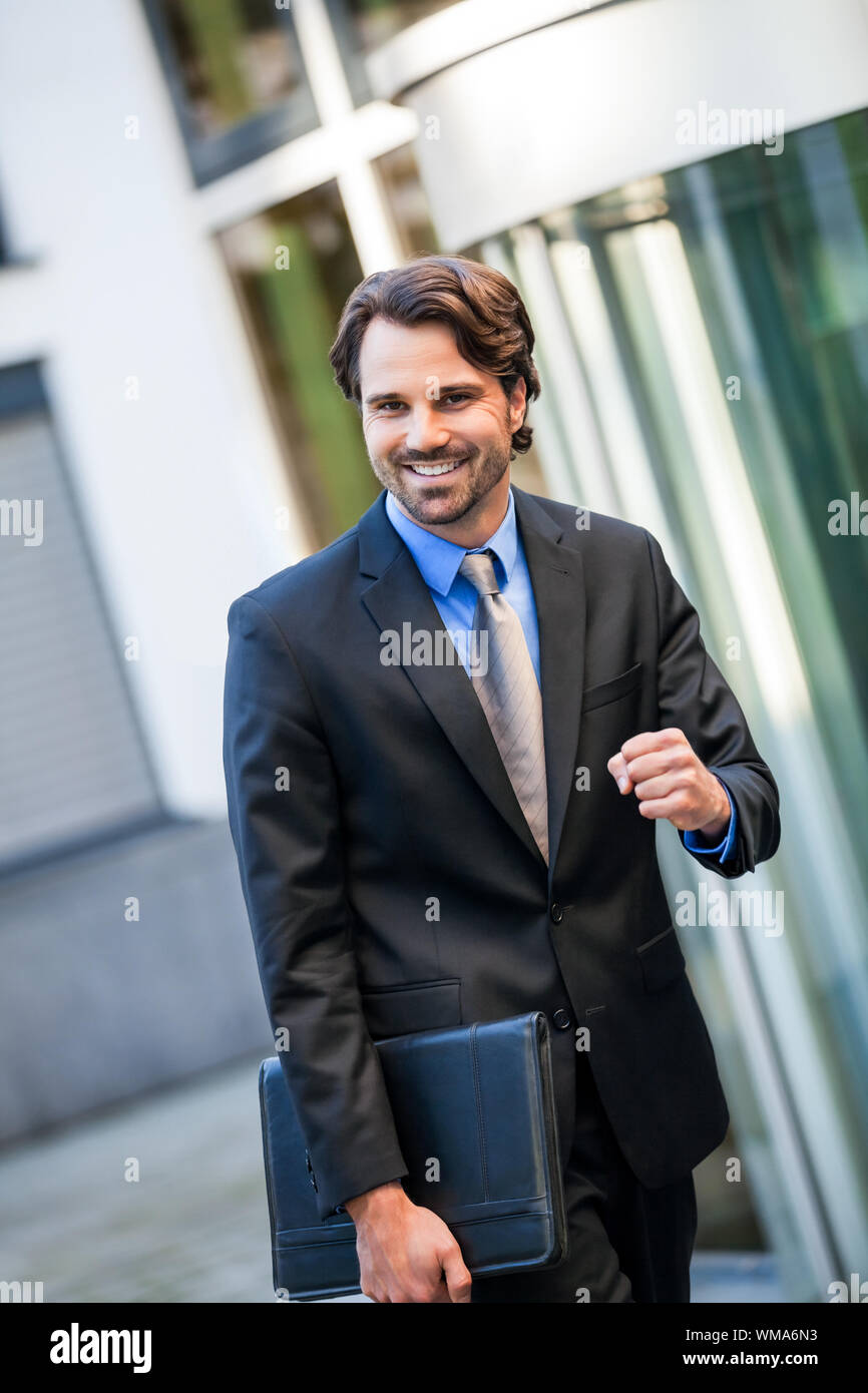 Motivated businessman punching the air Stock Photo - Alamy