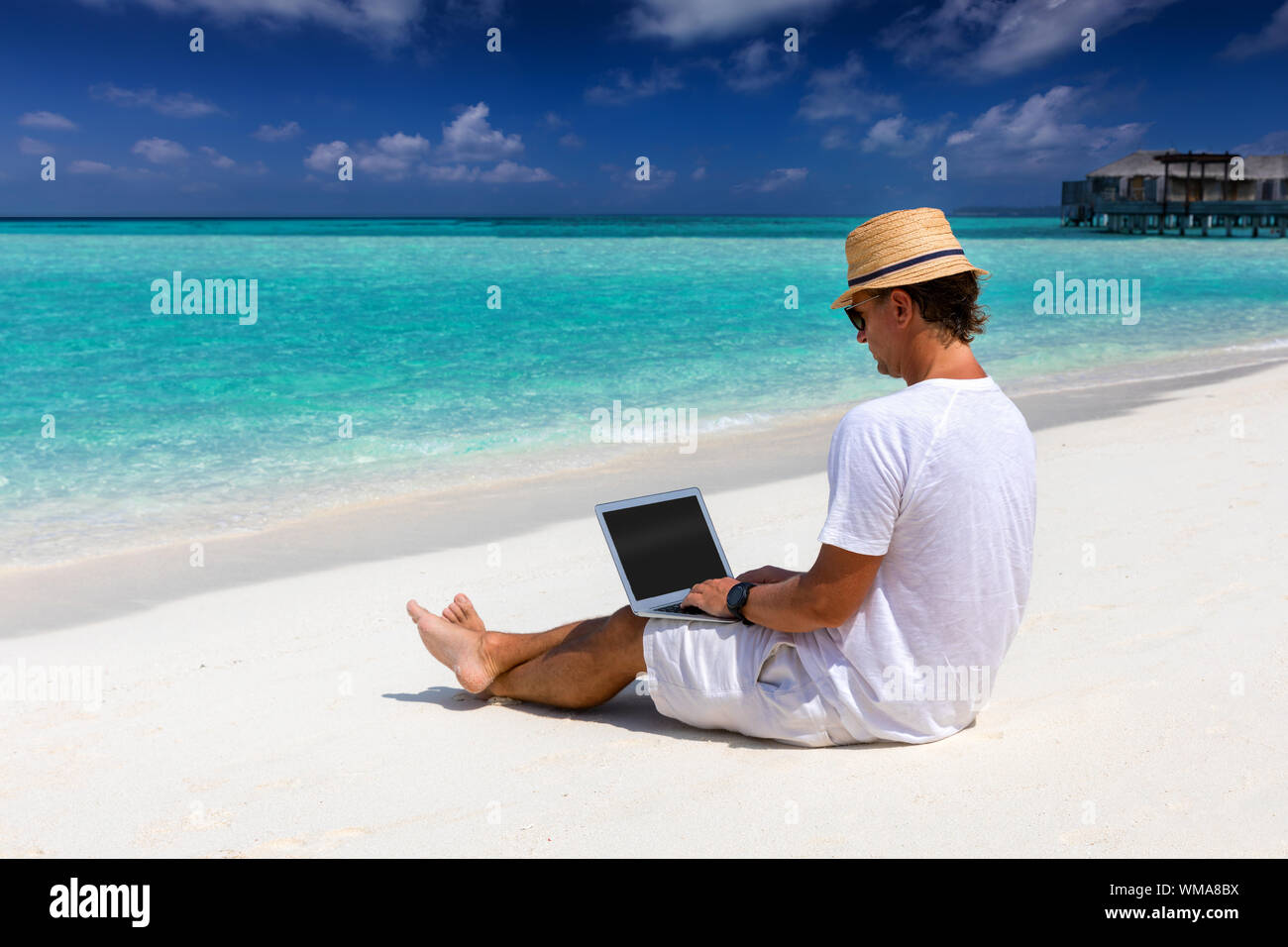 Man on laptop beach hi-res stock photography and images - Alamy