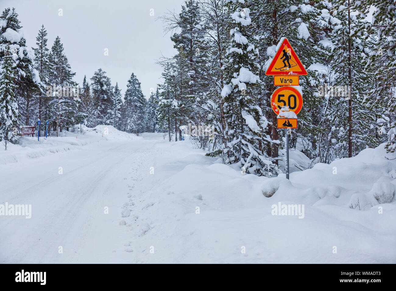 Warning traffic sign, warning skier and snowmobile sign on snowy arctic ...