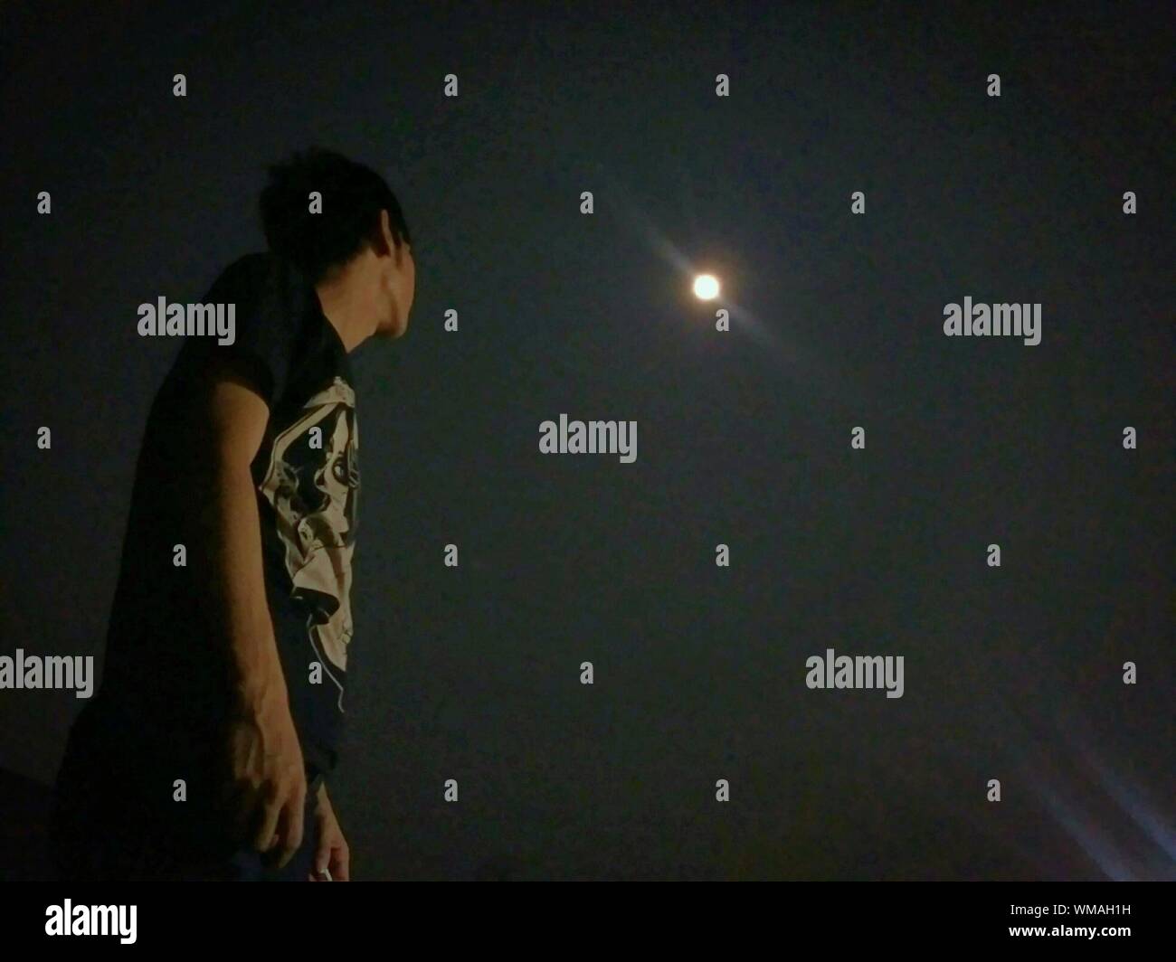 Man looking at moon hi-res stock photography and images - Alamy