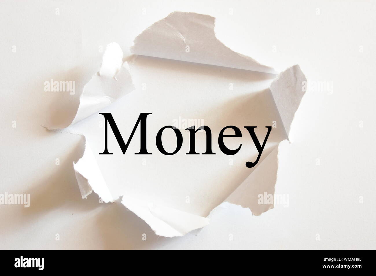 money in hole of blank paper showing business concept Stock Photo - Alamy
