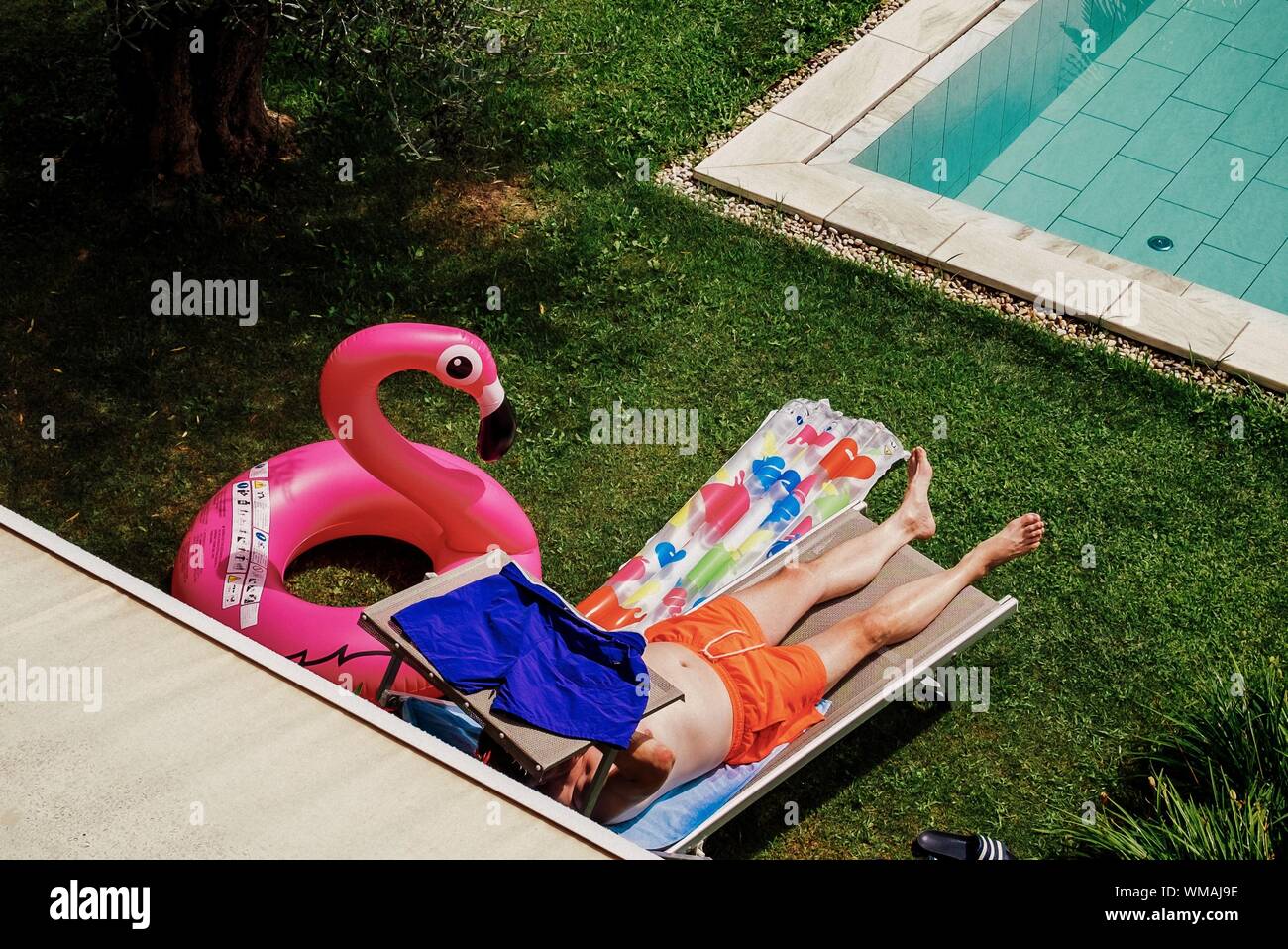 Men lying down sunbathing hi-res stock photography and images - Alamy