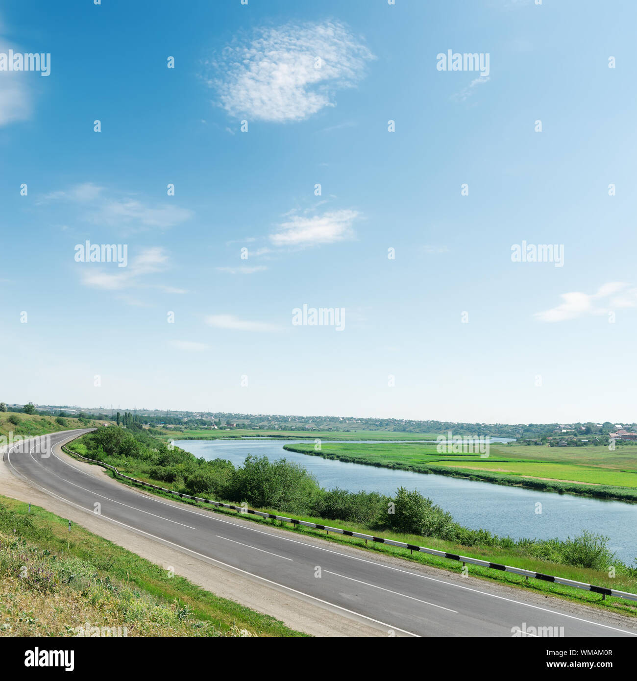 asphalt road along river and blue sky over it Stock Photo - Alamy