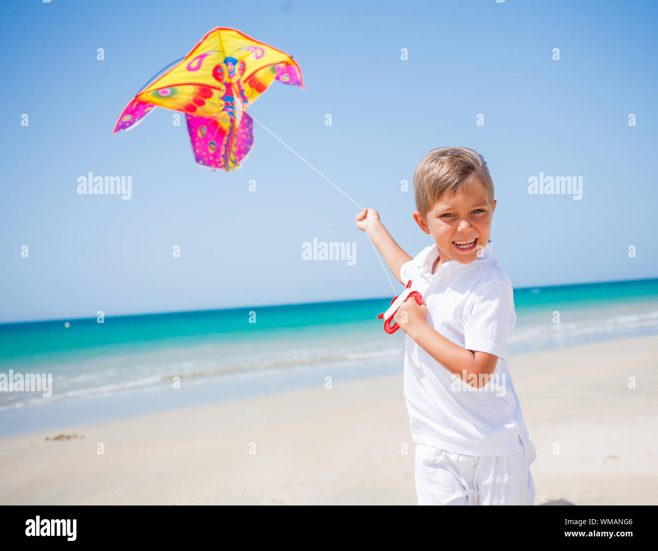 Blond boy flying kite hi-res stock photography and images - Alamy