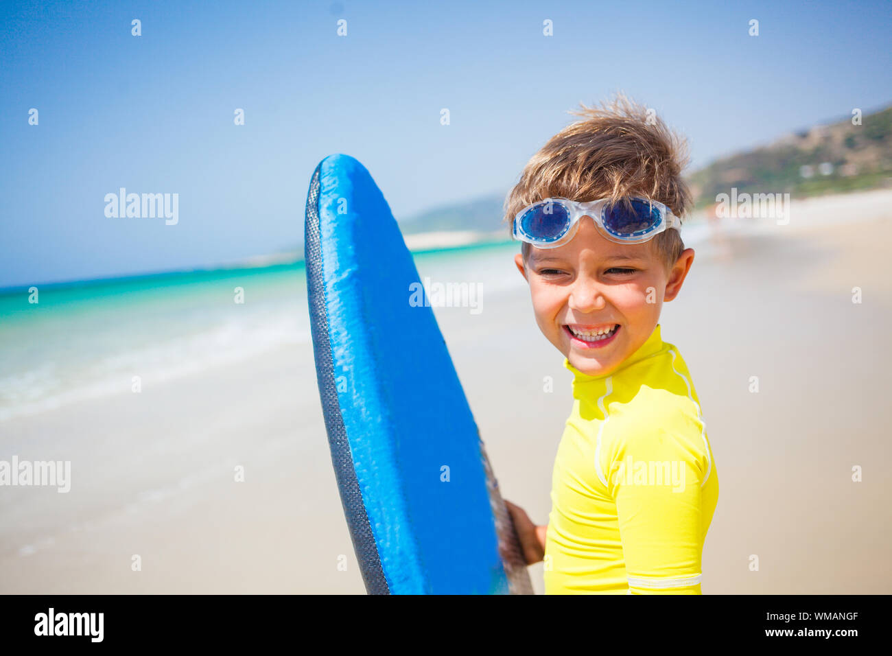 Portrait of little boy in yellow has fun surfing Stock Photo - Alamy
