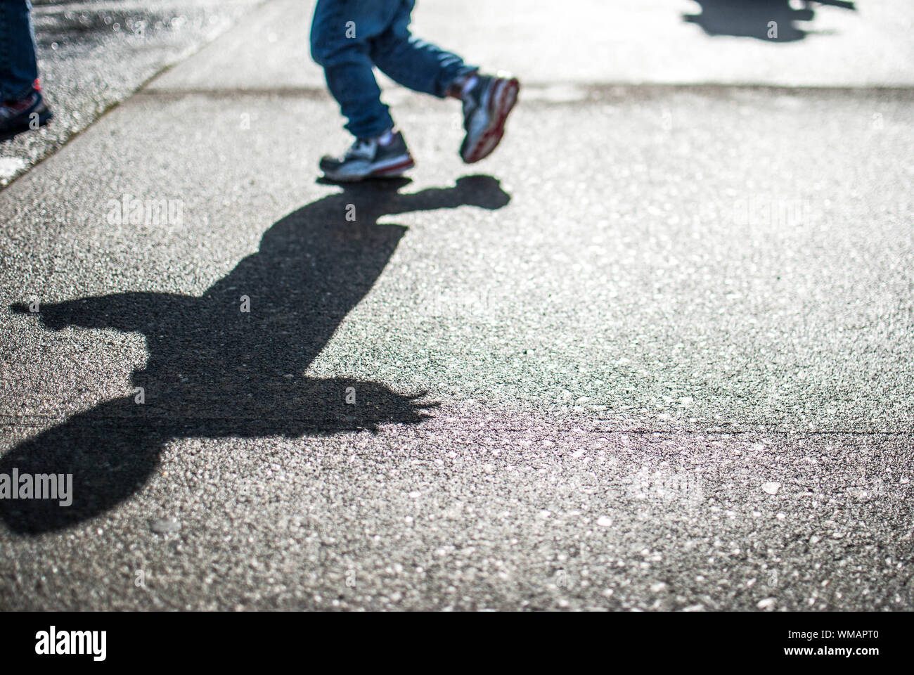Shadow Of A Child On Street Stock Photo - Alamy