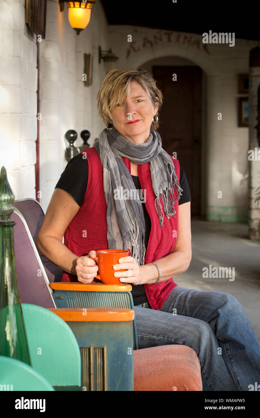 Pretty lady drinking morning coffee on porch Stock Photo - Alamy