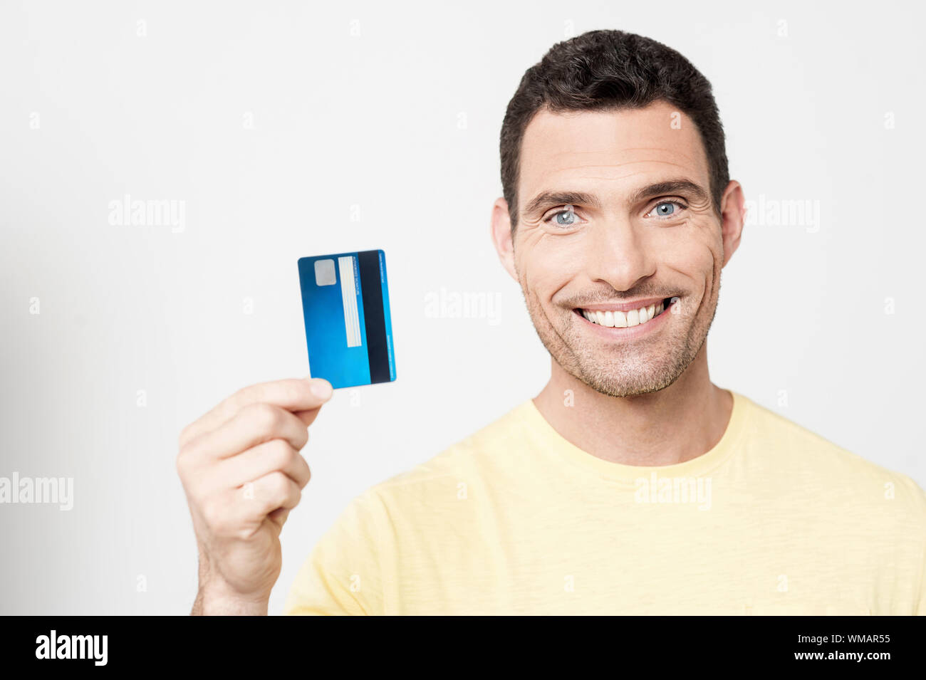 Happy man showing his credit card to camera Stock Photo - Alamy