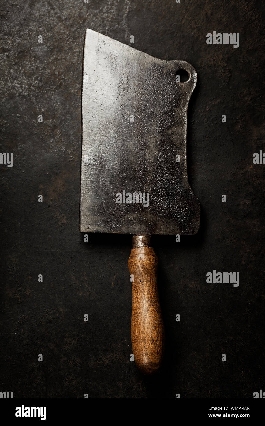 Meat cleaver knife on dark vintage background Stock Photo - Alamy