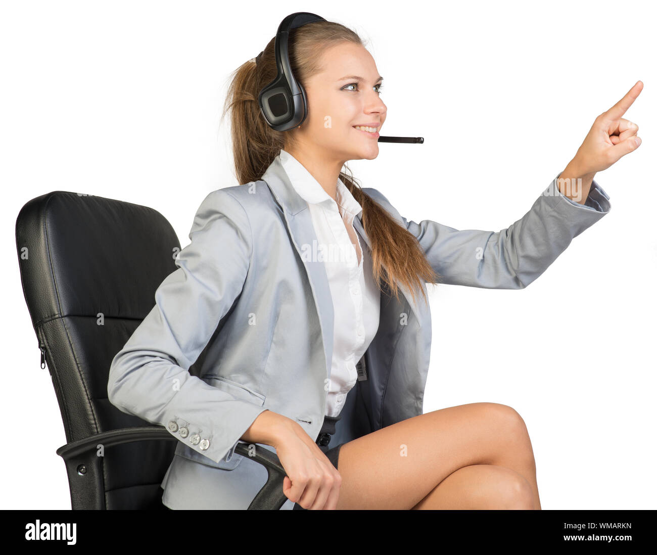 Businesswoman in headset sitting on office chair, touching or pressing ...