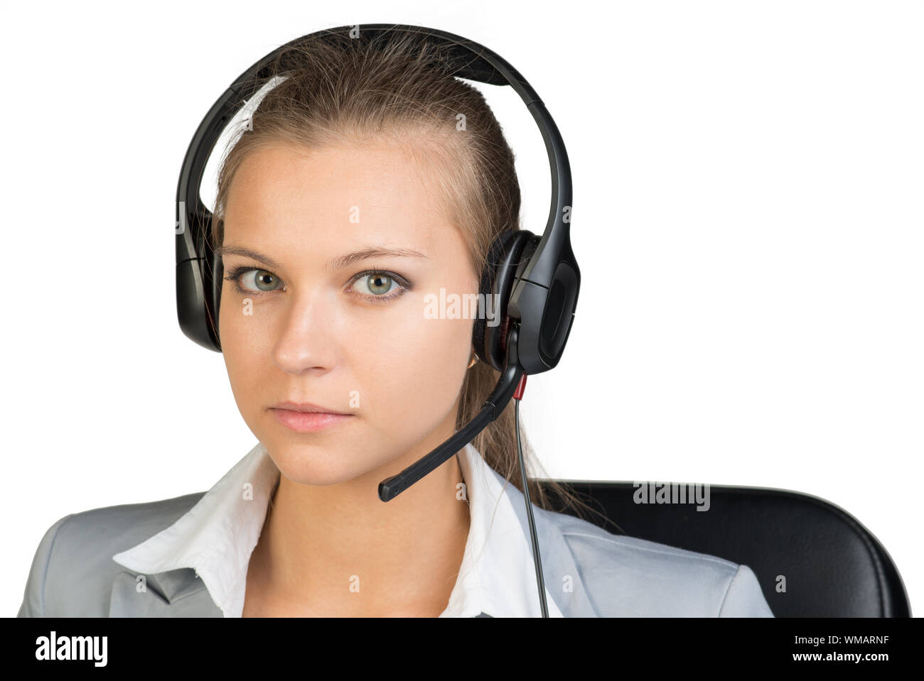 Businesswoman in headset looking at camera. Isolated over white ...