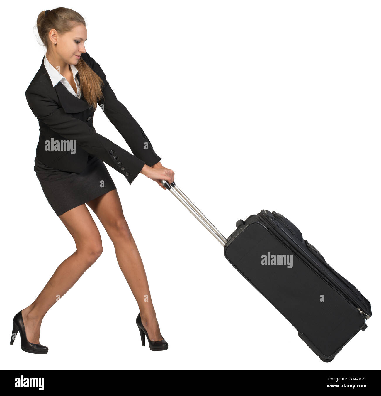 Businesswoman dragging heavy wheeled suitcase with both hands. Isolated ...