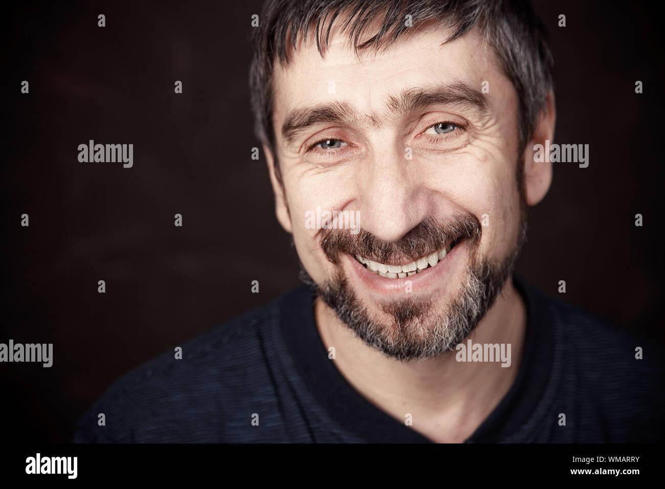 Portrait of smiling man in white Stock Photo - Alamy