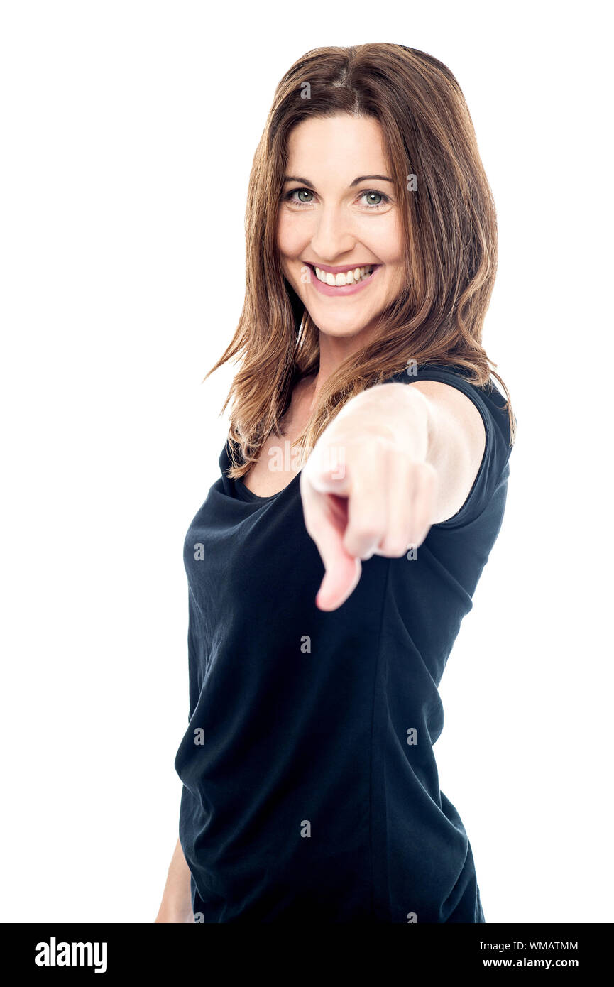 Cheerful woman pointing finger towards camera Stock Photo - Alamy