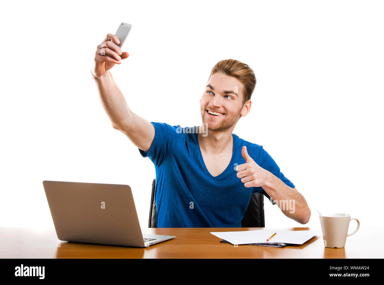 Good looking young man working in the office and taking a selfie Stock ...