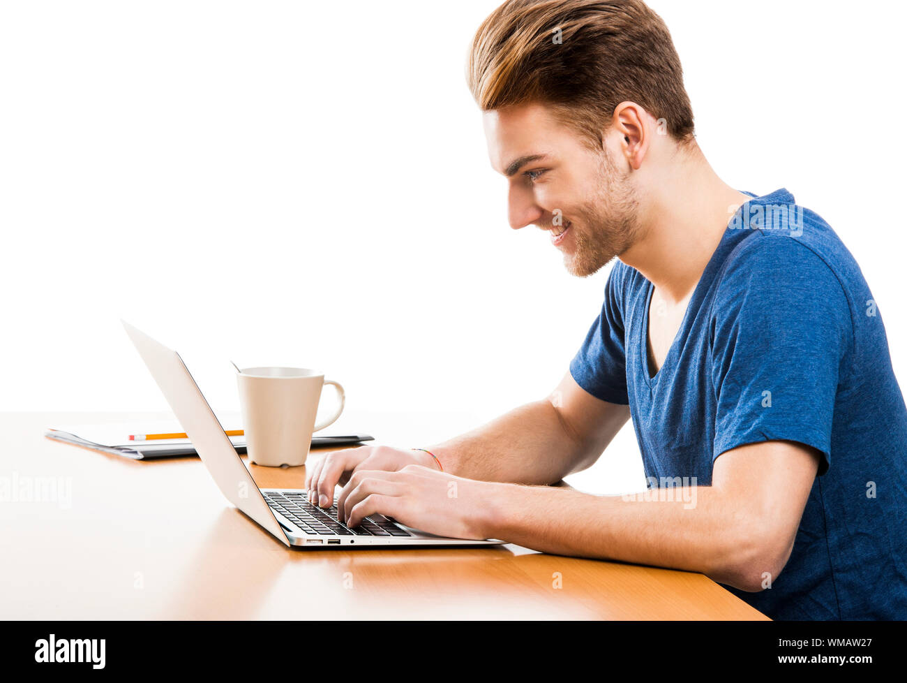 Good looking young man in the office working, isolated over white ...