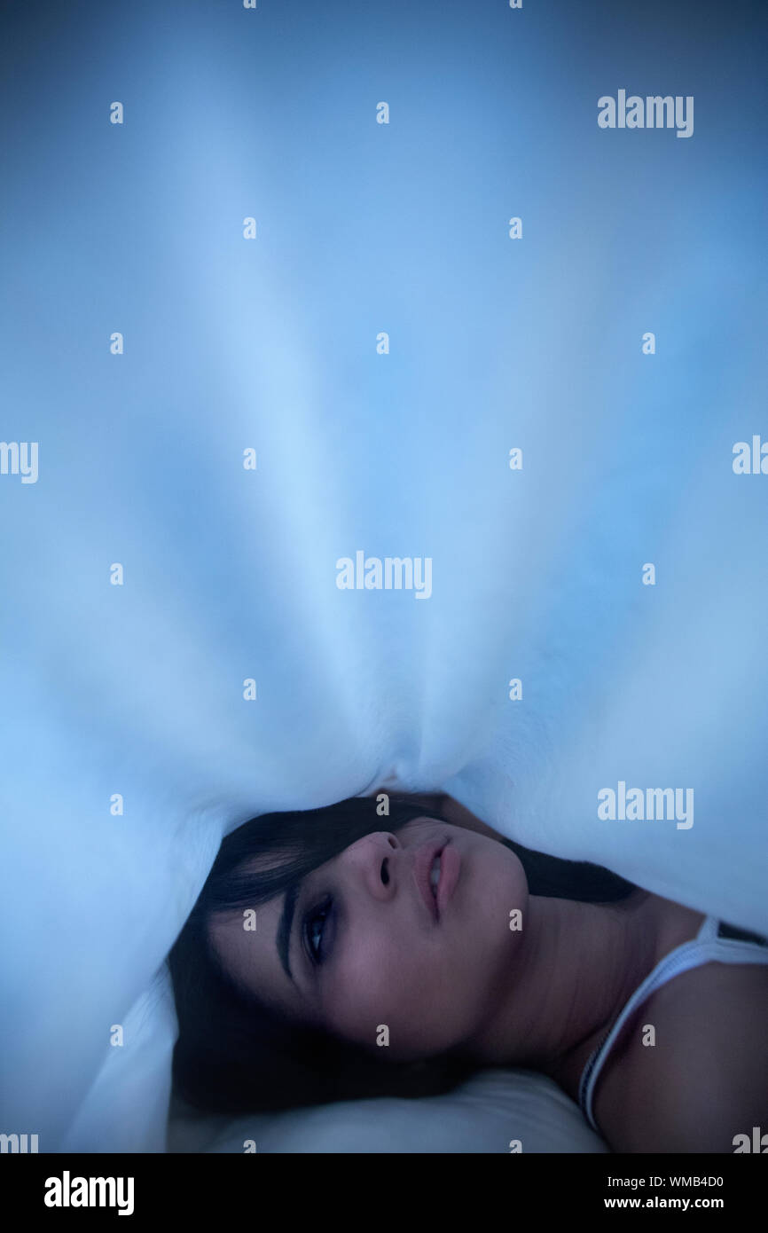 Sad young woman lying on hi-res stock photography and images - Alamy