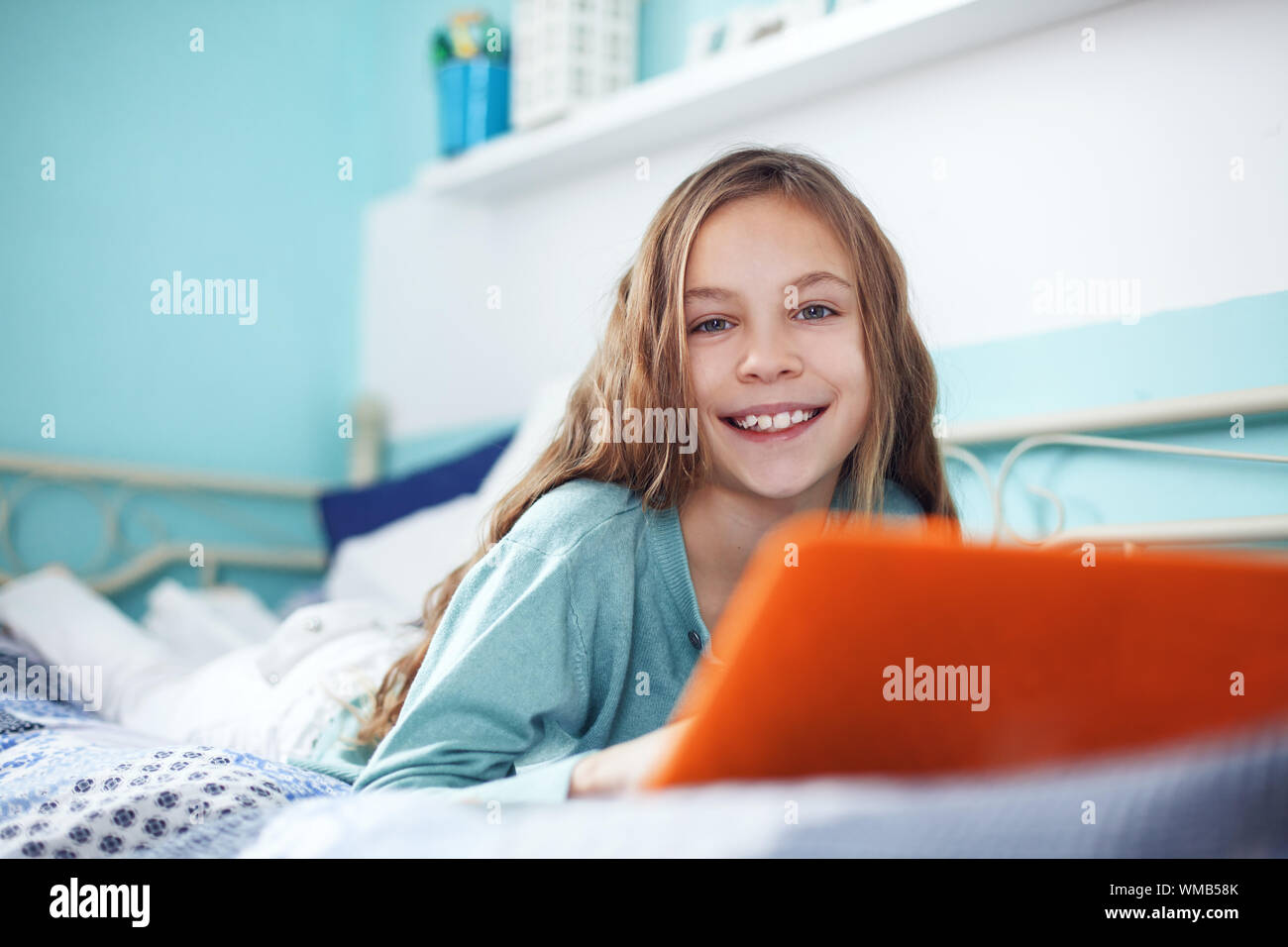 8 years old child having fun using laptop at her bedroom Stock Photo ...